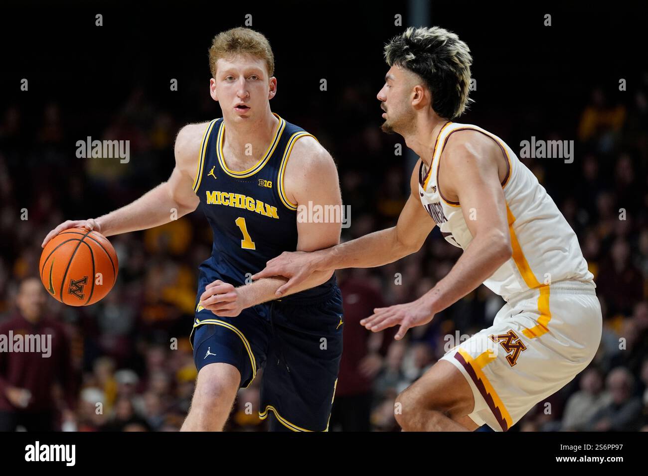 Michigan center Danny Wolf (1) dribbles down the court as Minnesota ...