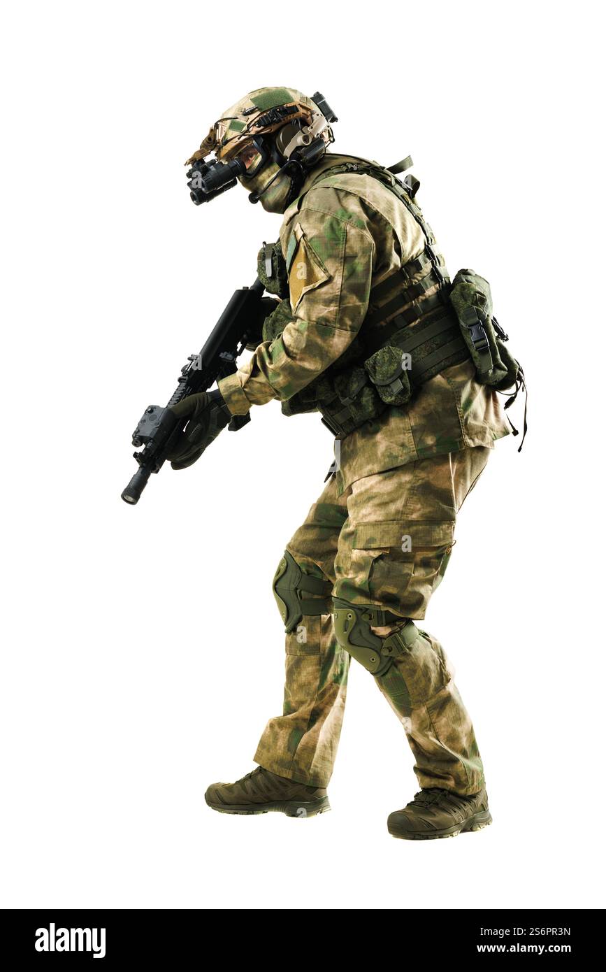 A fully equipped soldier in modern combat attire holding a firearm in a ...