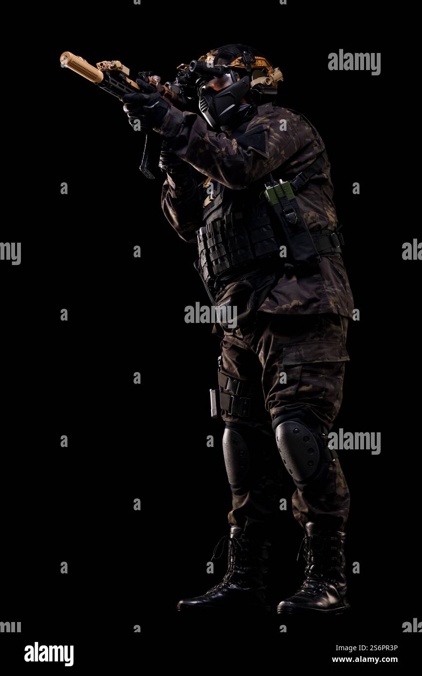 A soldier wearing tactical military gear with a firearm, aiming with ...