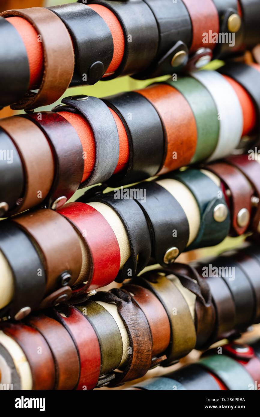 A row of leather bracelets are displayed in a store. The bracelets are ...