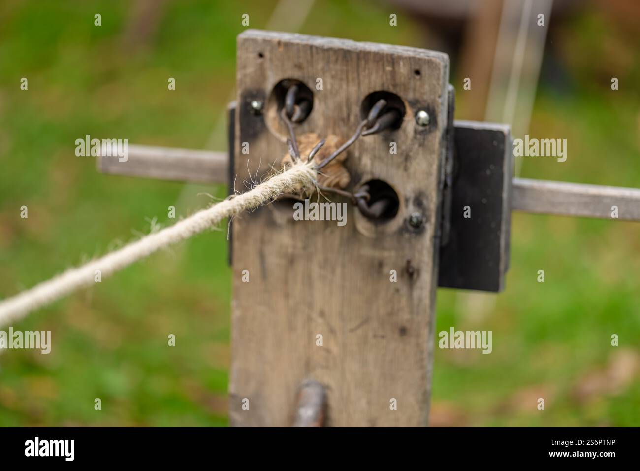 A wooden contraption with a rope attached to it. The contraption is ...