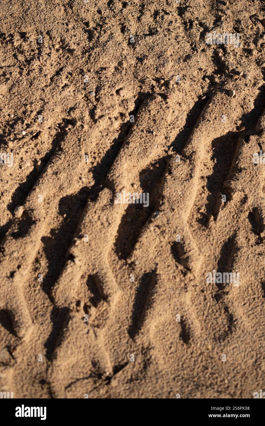 photo Close-Up of Tire Track Patterns Imprinted on Sandy Surface ...