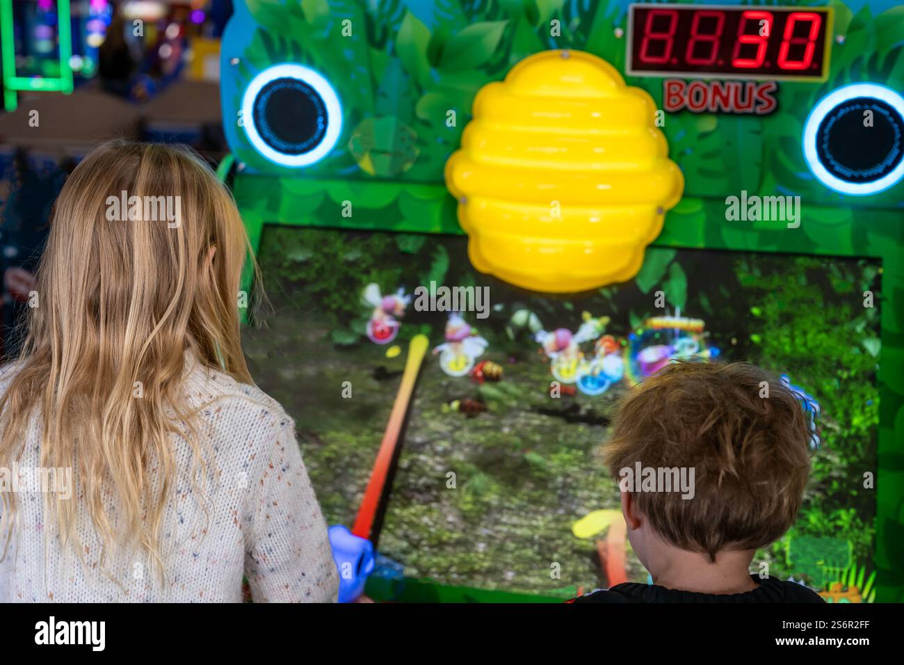 Selective focus on children playing arcade games for fun with blurred ...