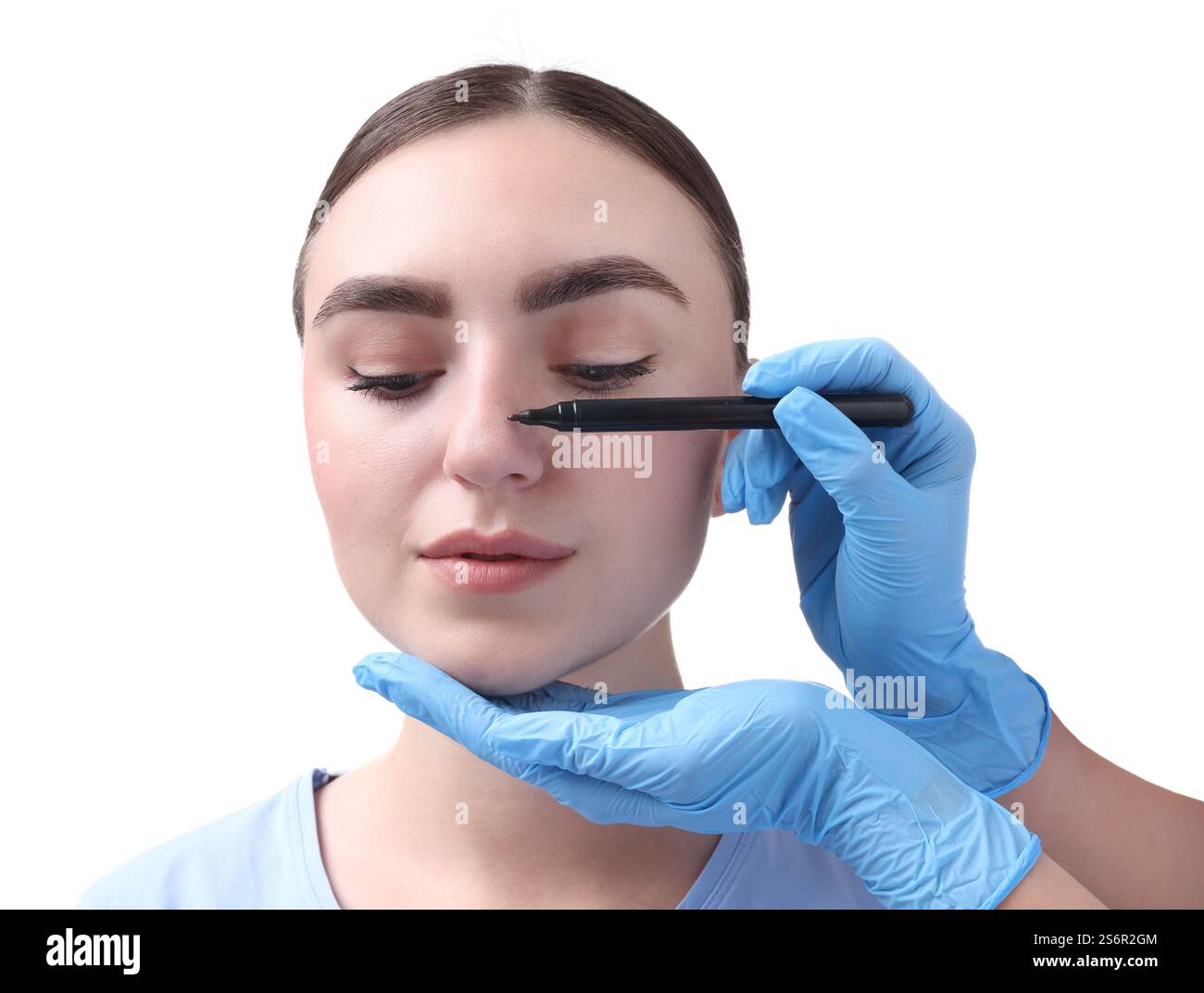 Doctor drawing marks on patient's nose for plastic surgery operation ...