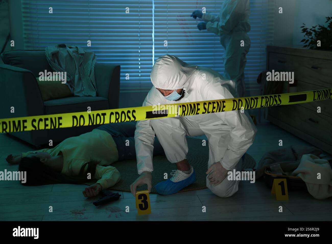 Forensic experts working at crime scene with dead woman's body indoors ...