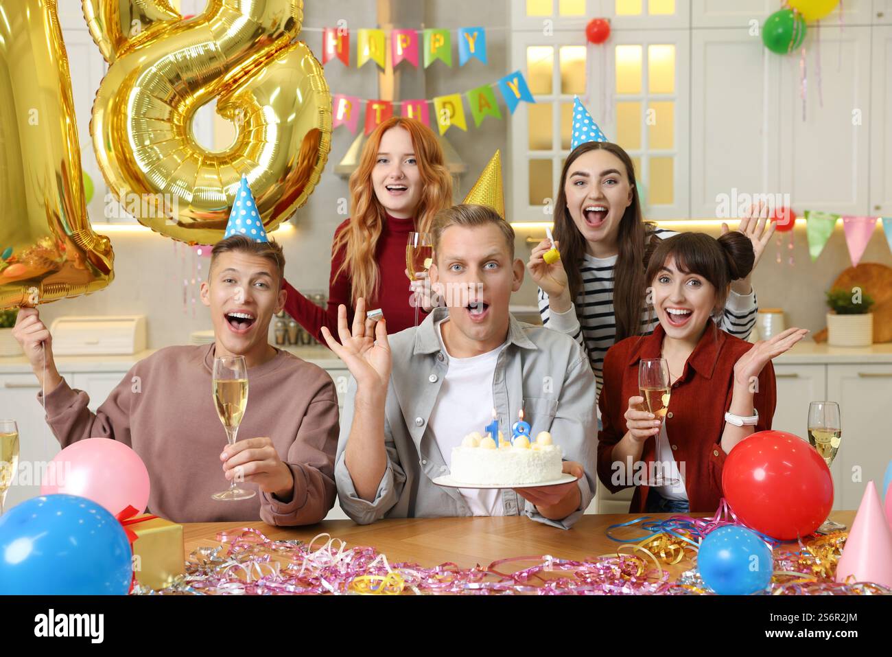 18th birthday. Group of friends with tasty cake having coming of age ...