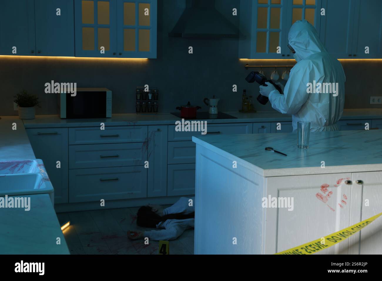 Forensic expert with camera working at crime scene in dark room Stock ...