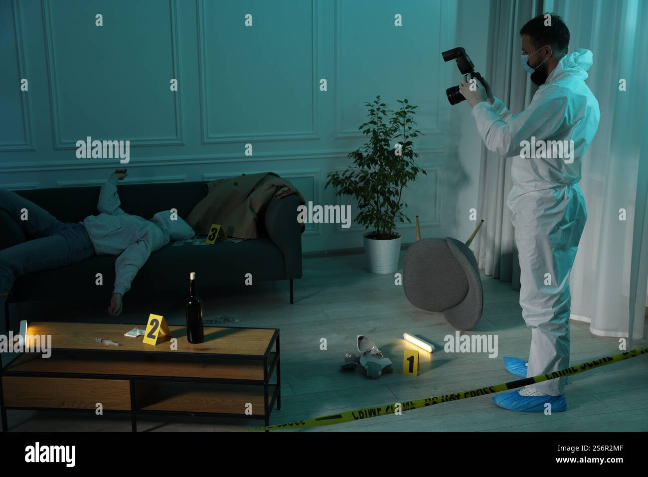 Forensic expert with camera working at crime scene and dead woman's ...