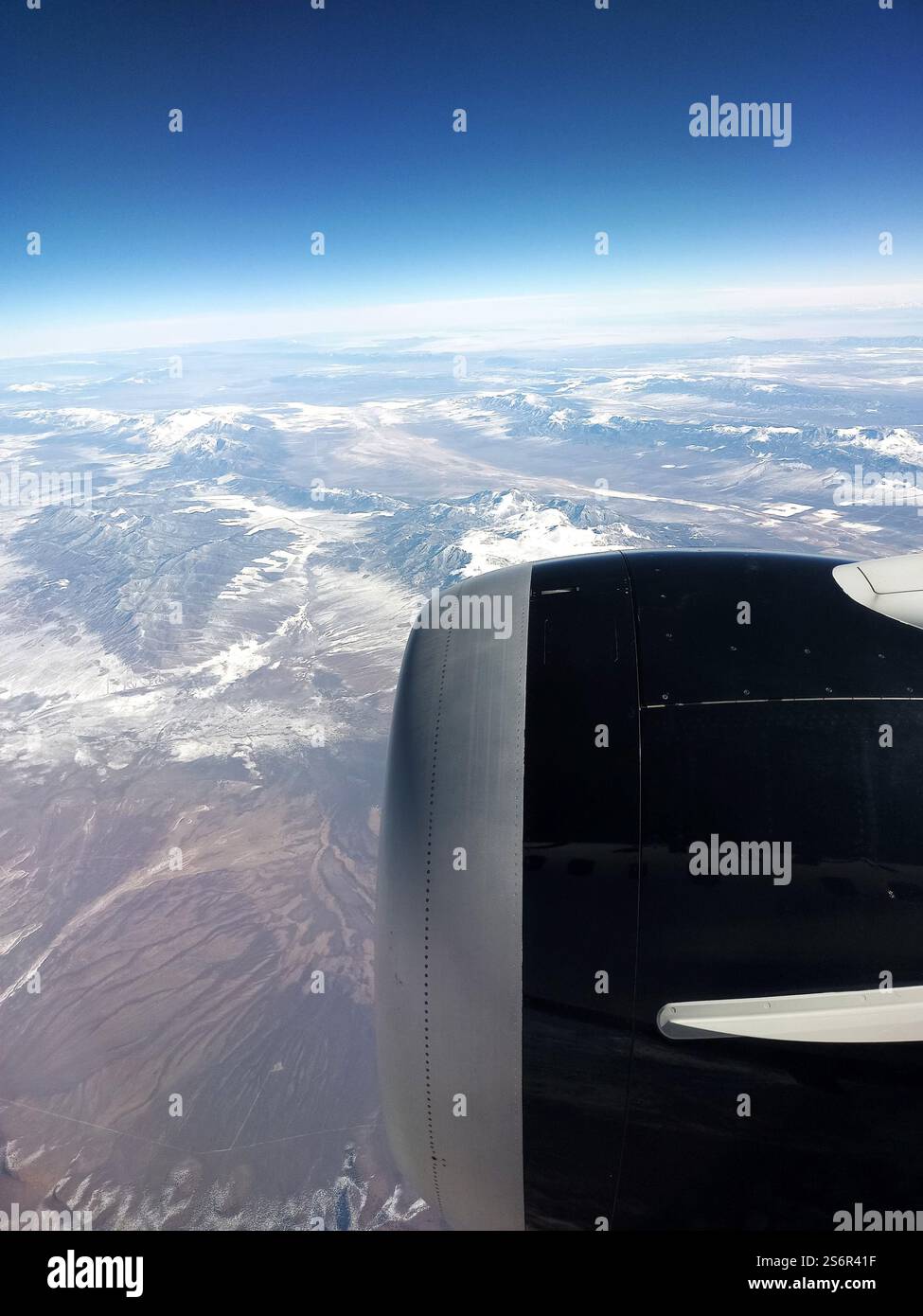 Window view of airplane flying over snowy mountains of Vancouver Canada ...