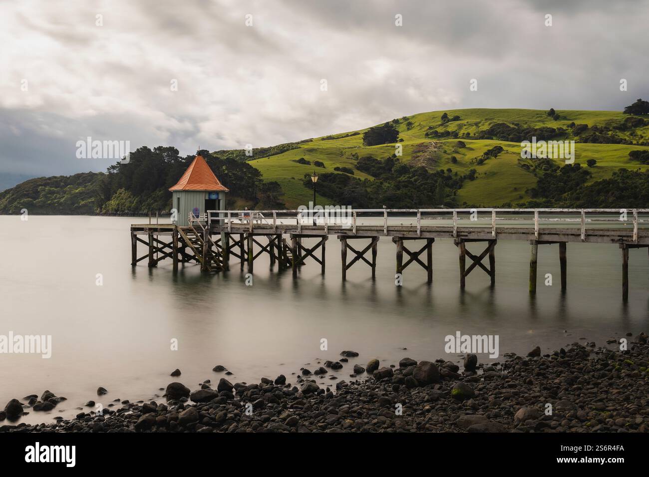 The historic wooden jetty at Daly's Wharf in Akaroa on New Zealand's ...
