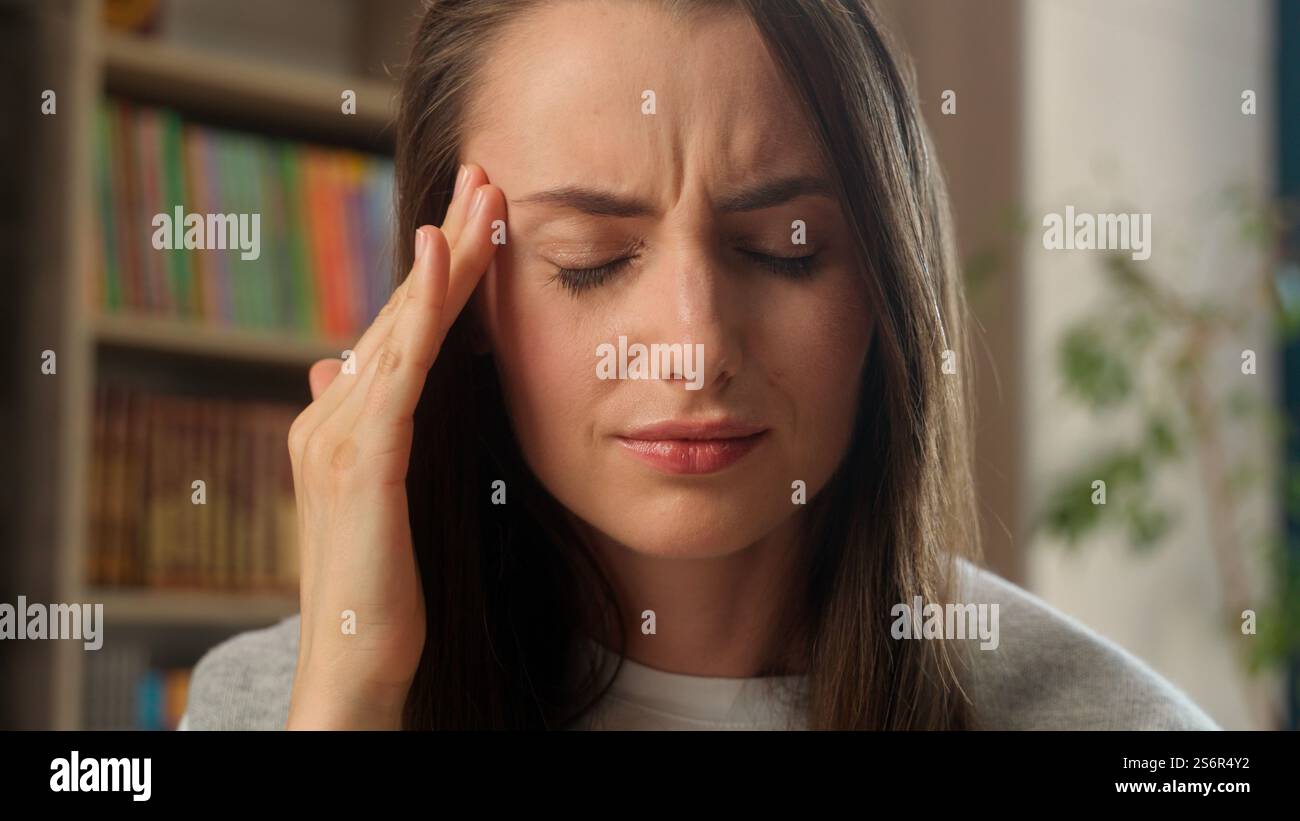 Tired exhausted Caucasian woman massage temples tension headache sick illness female girl ...