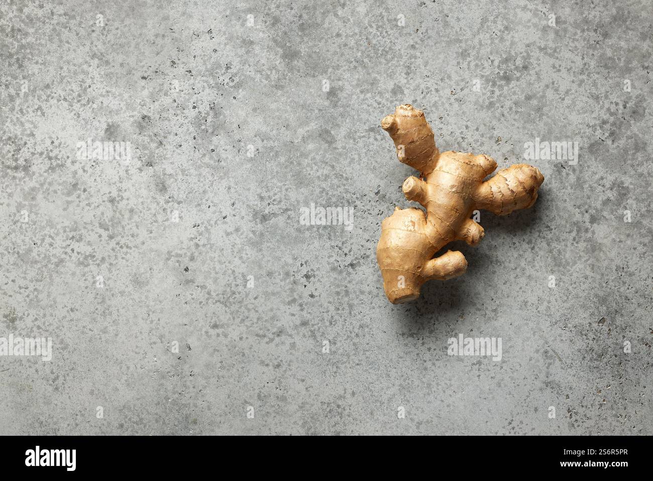 fresh raw ginger on grey table background, top view Stock Photo - Alamy