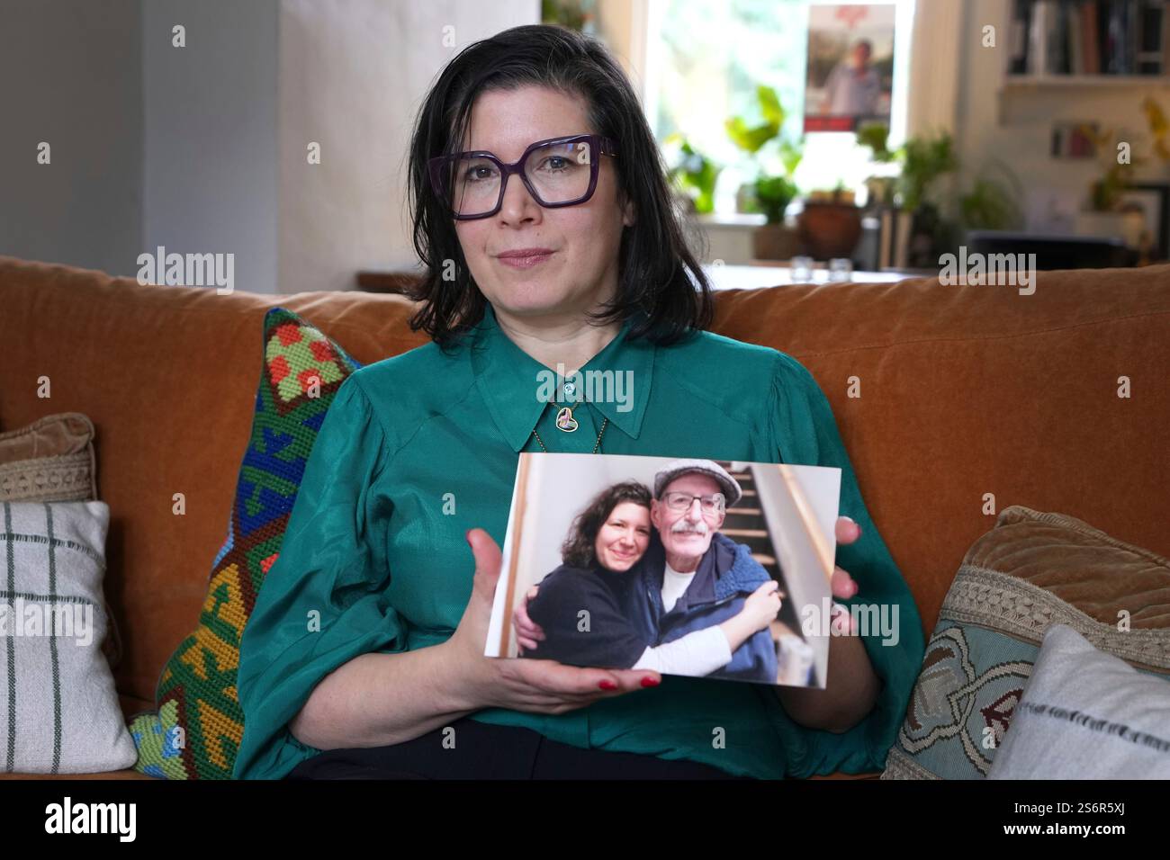 Sharone Lifschitz holds a photograph of herself with her father, Oded ...