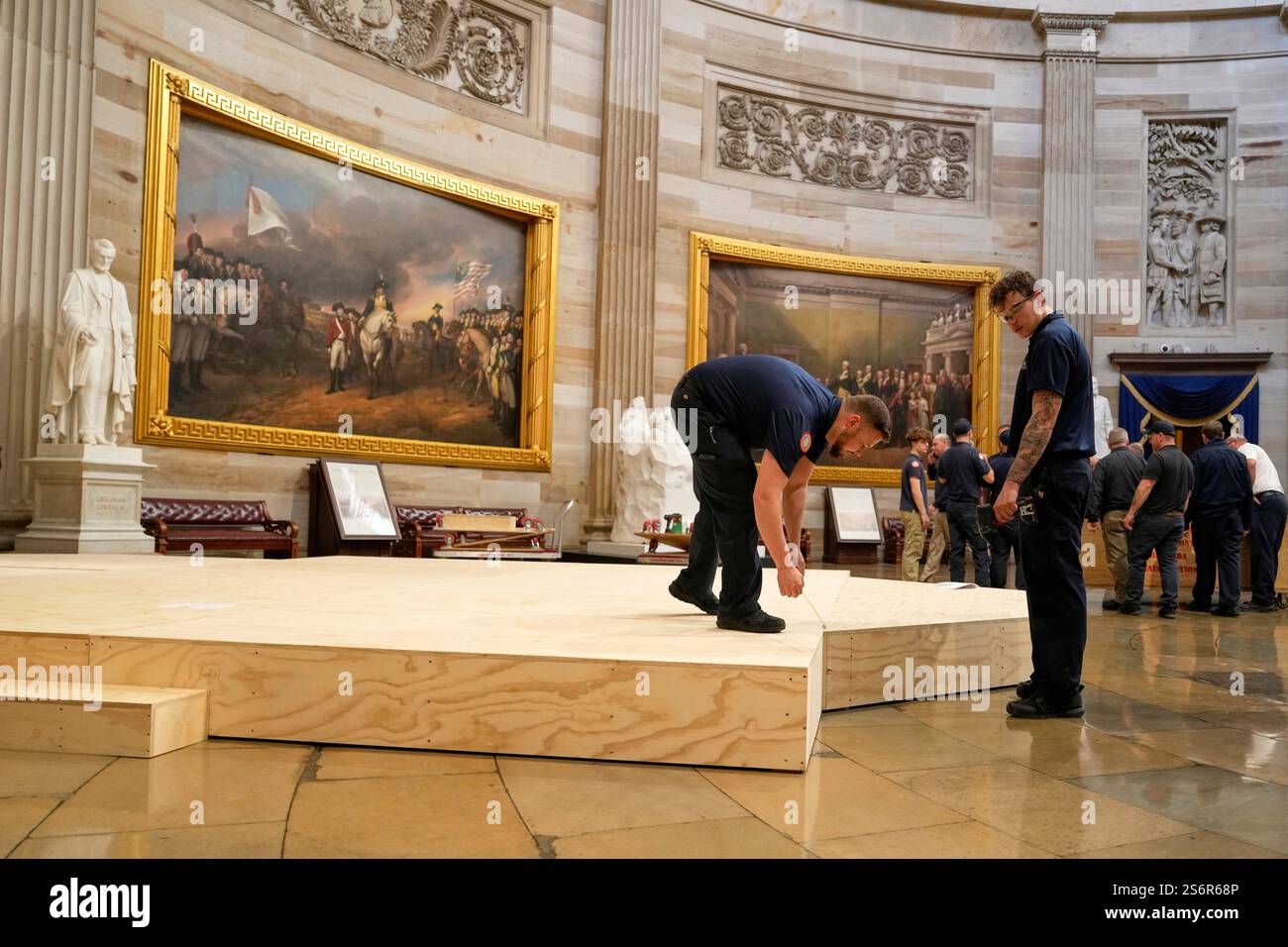 Workers build a stage in the U.S. Capitol Rotunda in Washington Friday ...