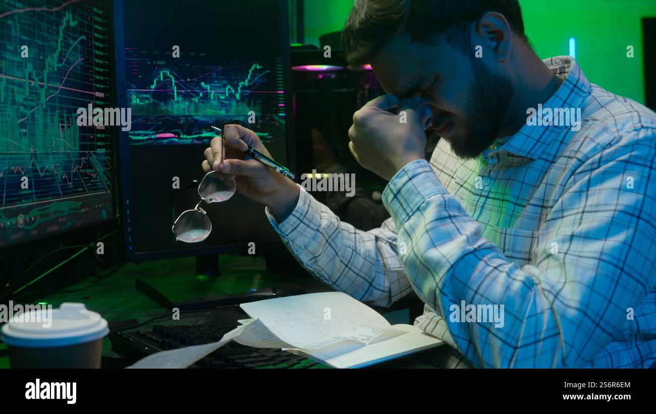 Tired Arabian Indian man male guy analyzing code monitor computer takes ...