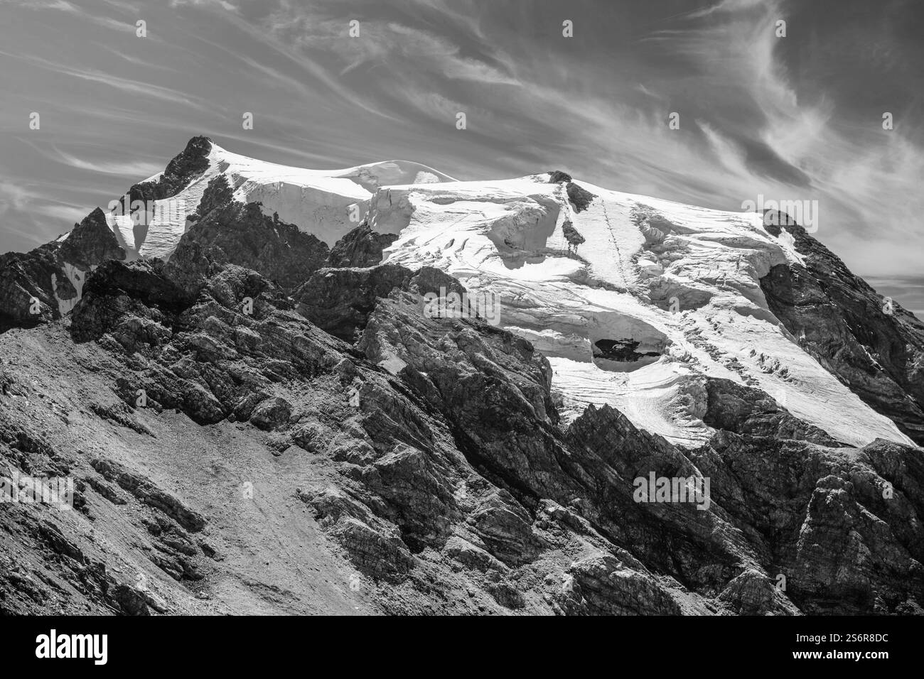 The towering Ortles Mountain stands grand under blue skies, its snowy ...