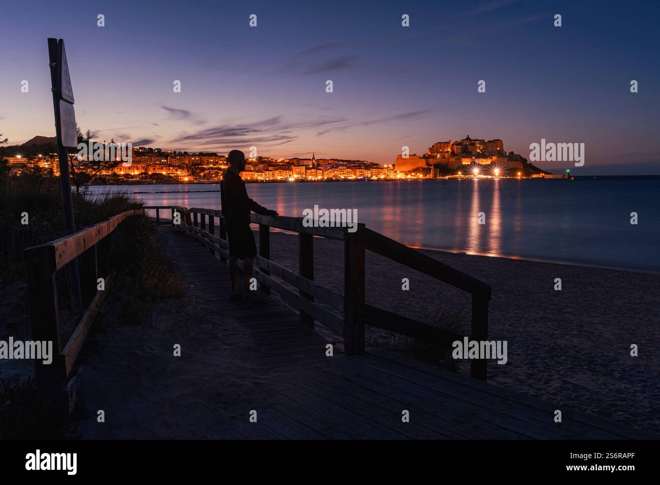 The town of Calvi at sunset on the town's long sandy beach. The ...