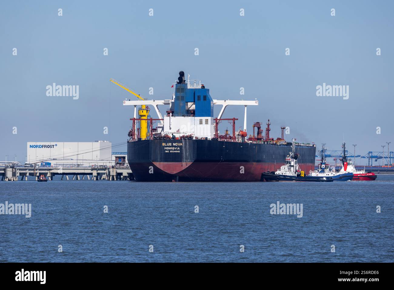 Crude oil tanker Blue Nova is supported by tugs during mooring at the ...
