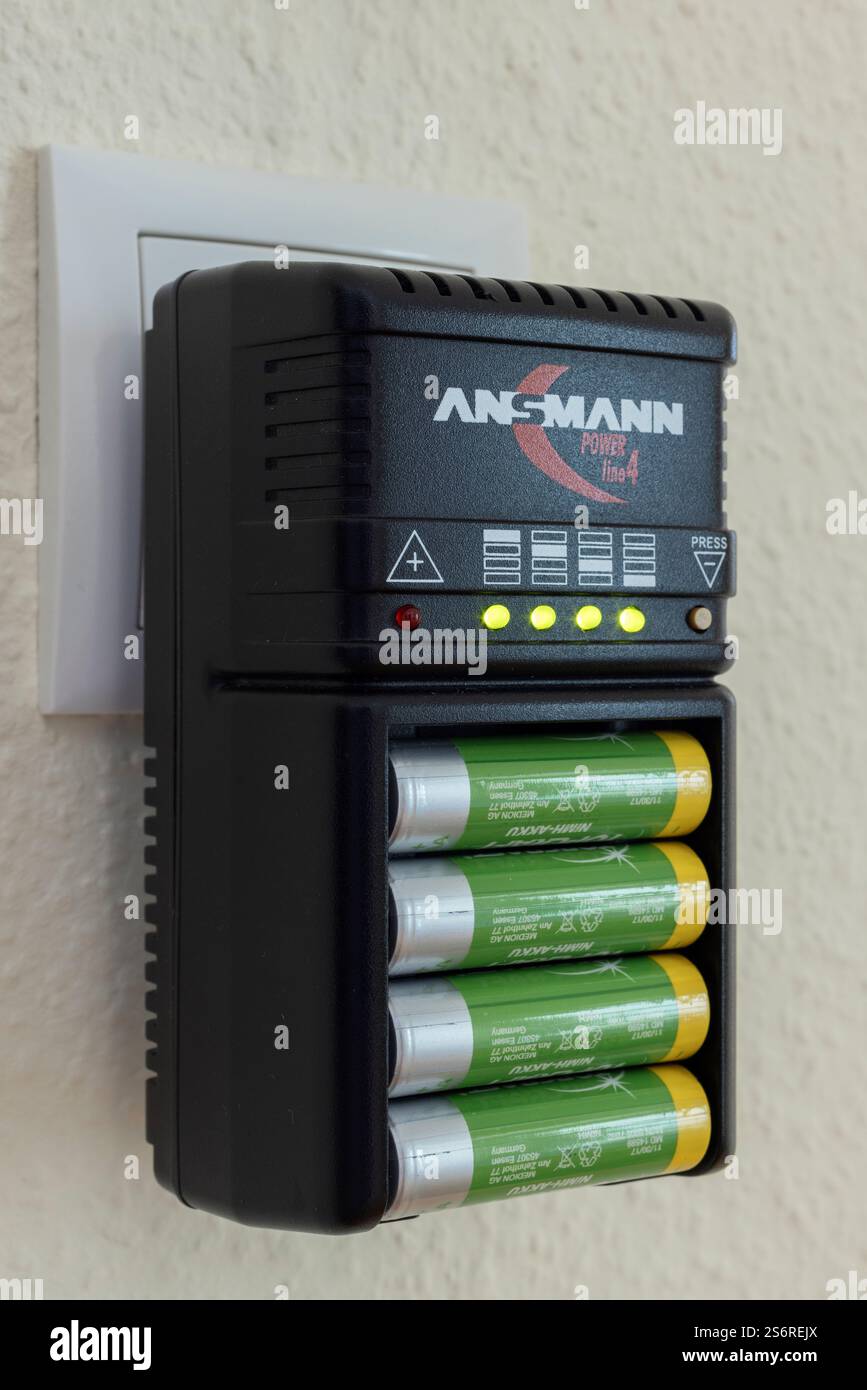 Ansmann battery charger, four rechargeable AA batteries inserted in a ...