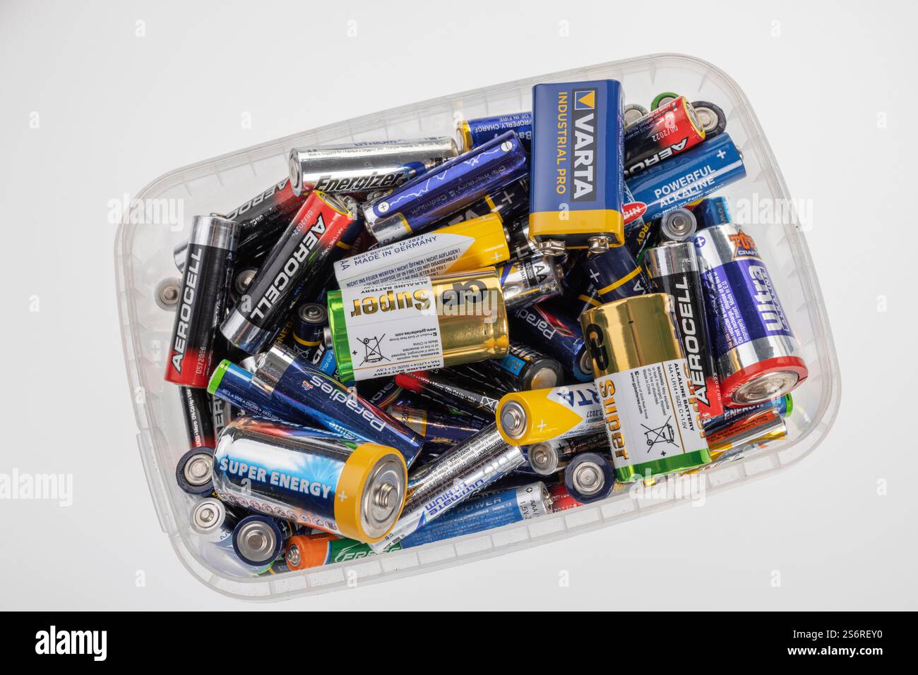 Used batteries in plastic container, white background Stock Photo - Alamy