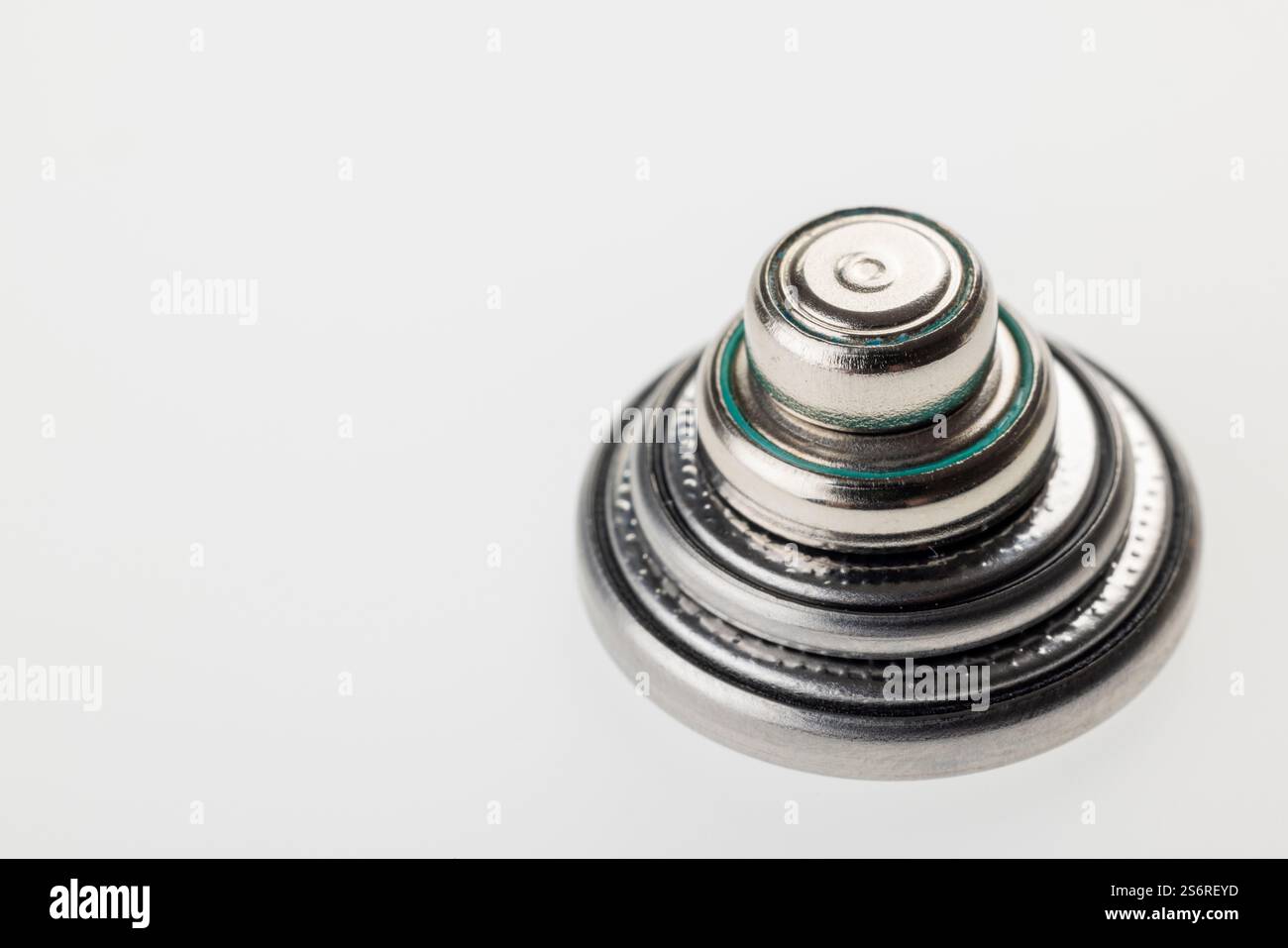 New button cells, stacked, various sizes, white background Stock Photo ...