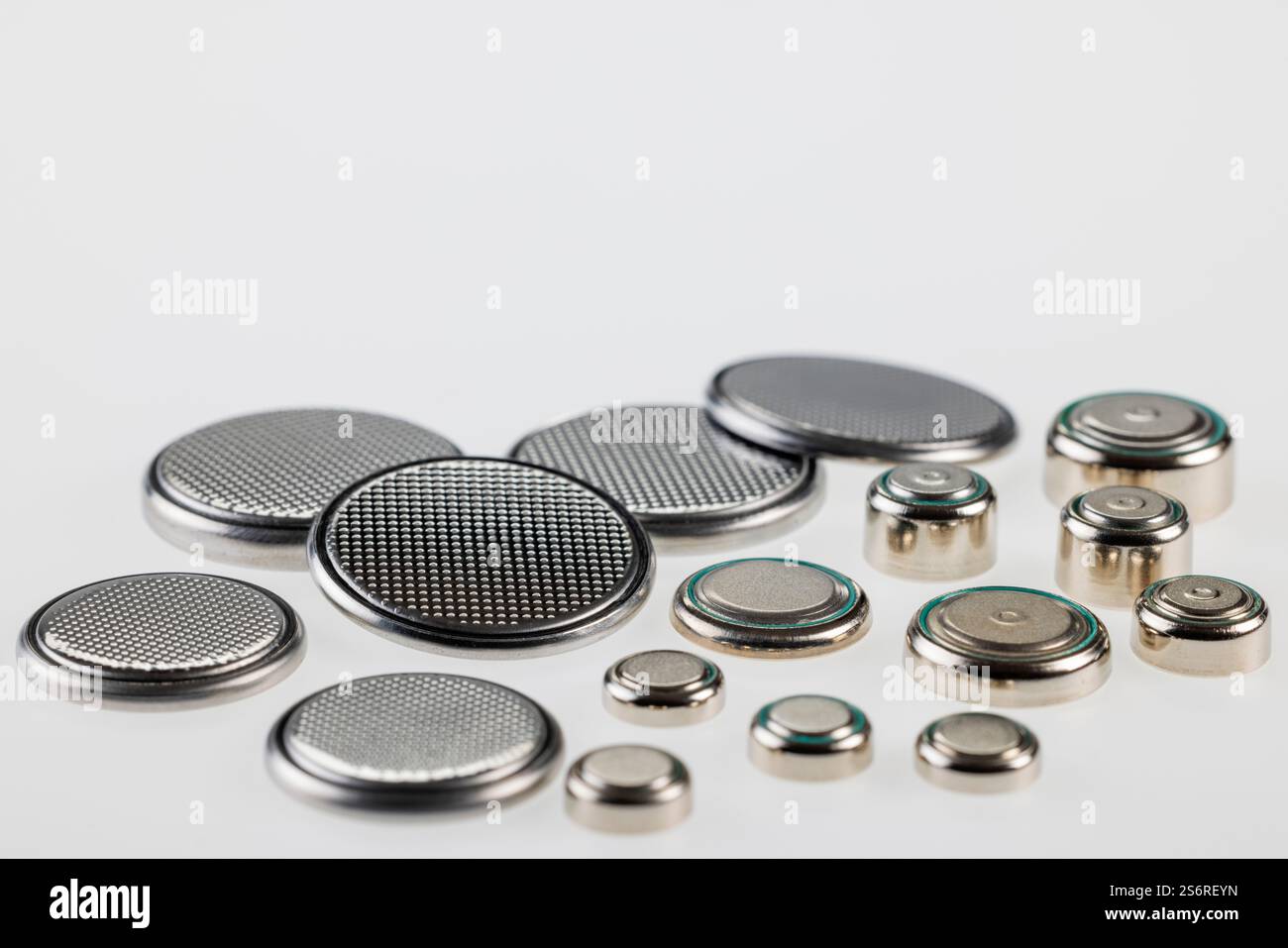 New button cells, various sizes, white background Stock Photo - Alamy