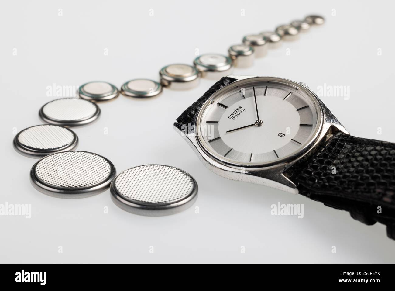 Button cells, various sizes, wristwatch, white background, symbol photo ...