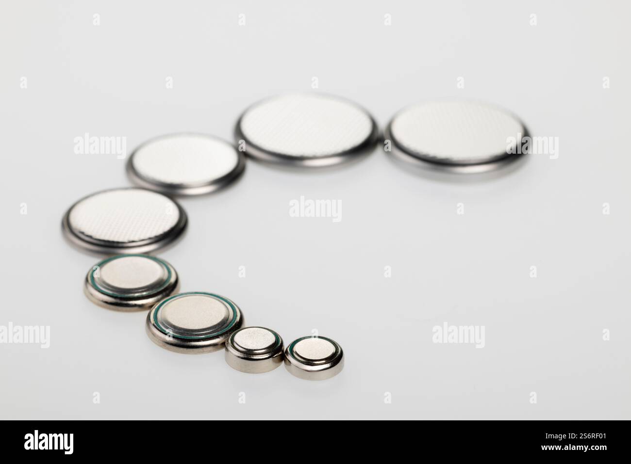 New button cells, various sizes, white background Stock Photo - Alamy
