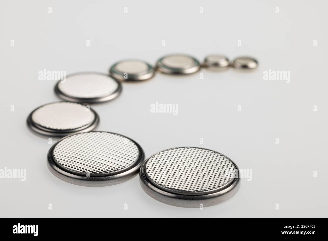 New button cells, various sizes, white background Stock Photo - Alamy