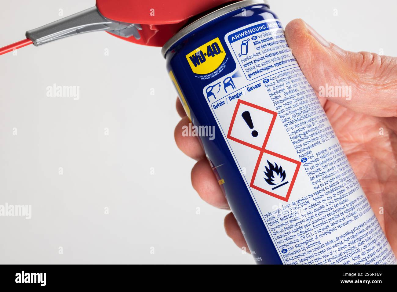 Man's hand holding WD-40 Smart Straw multifunctional spray, detail ...