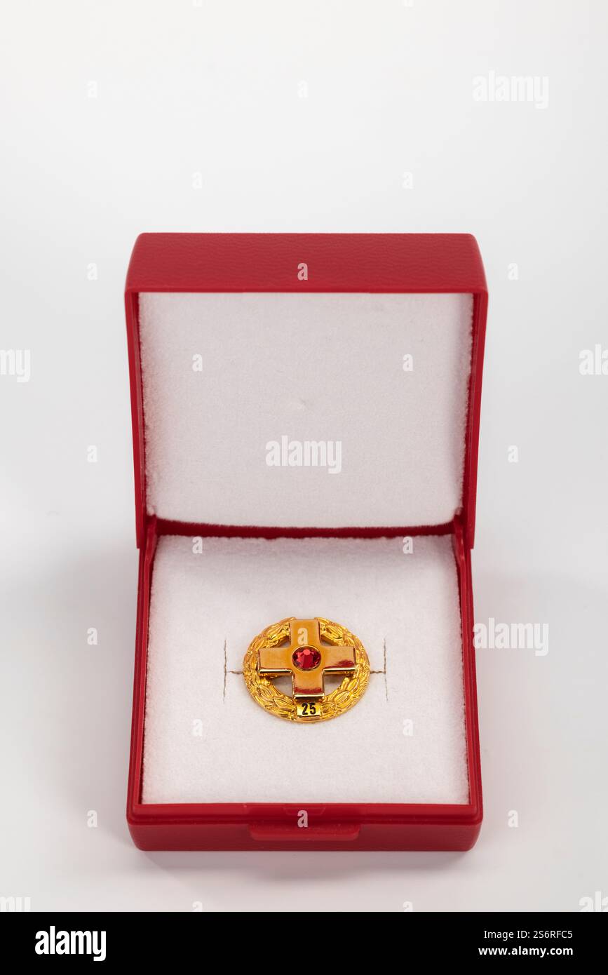 Case with the blood donor badge in gold for 25 blood donations, white ...