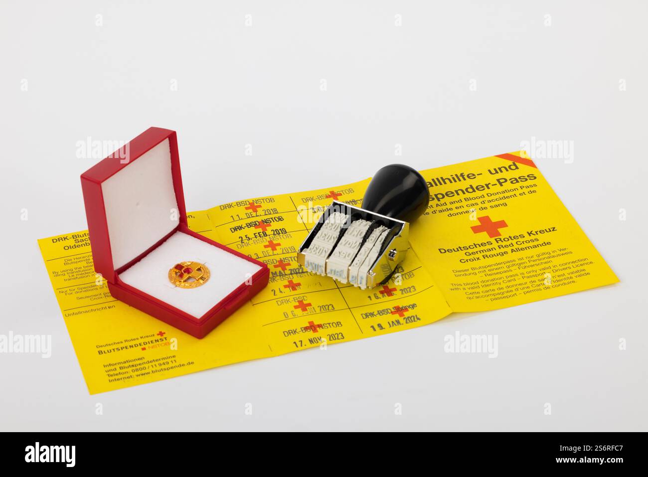 Full blood donor passport, date stamp, case with the blood donor pin ...