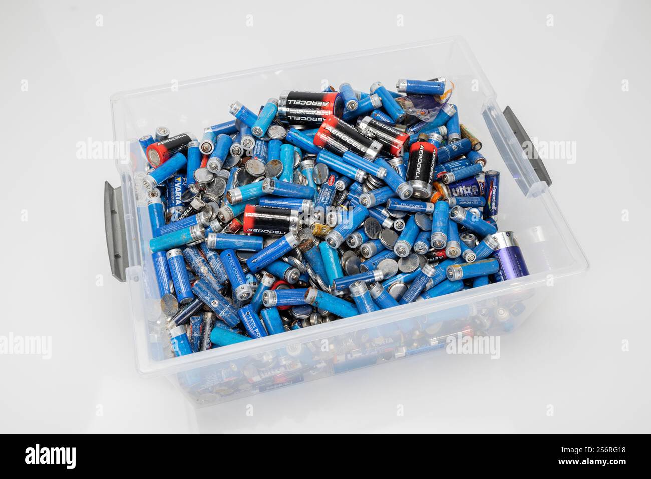 Used batteries in plastic container, various sizes and brands, white ...