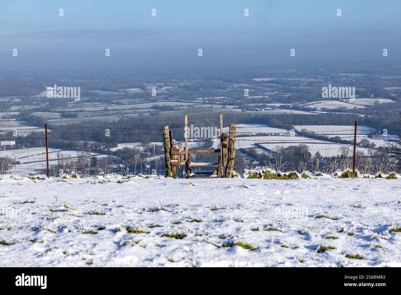 Snow on Ditchling Beacon in the South Downs, with a view of a stile on ...