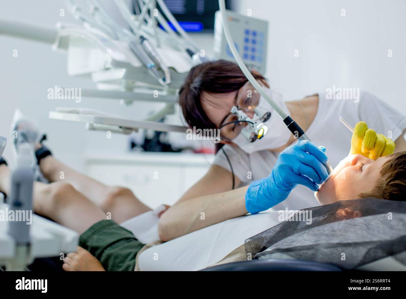 Children's dentistry. First examination at the dentist. A cute handsome ...