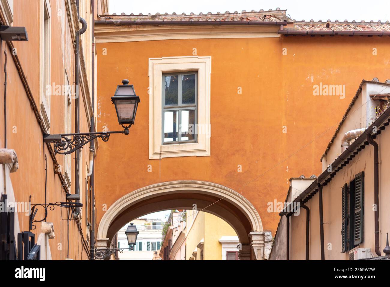 A traditional arched passageway provides a charming frame to the ochre ...