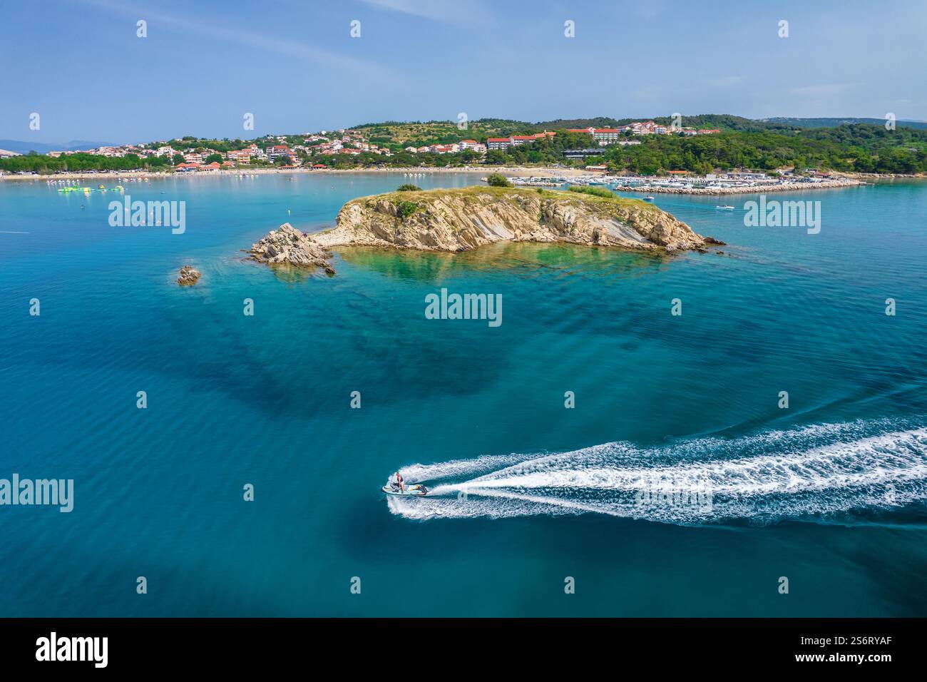 Aerial view of jet ski watercraft cruising in high speed in Adriatic ...