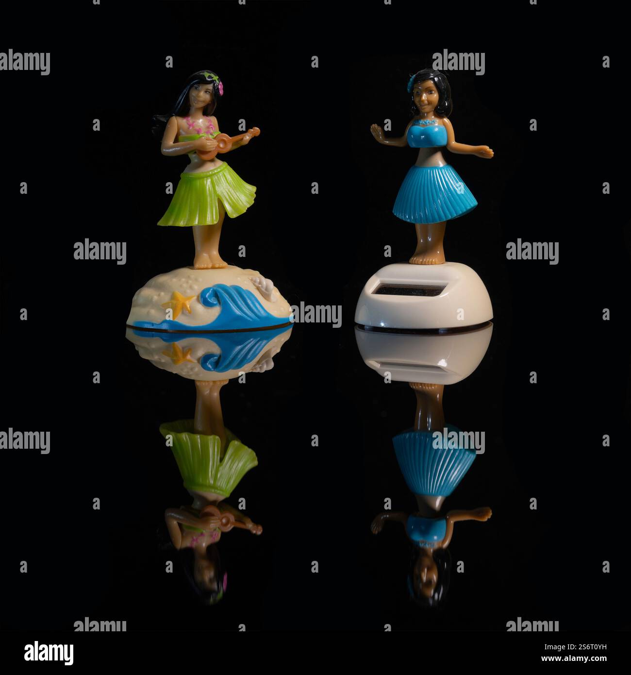 Solar Hawaiian Hula Dancer Figurines on Reflective Surface Against ...