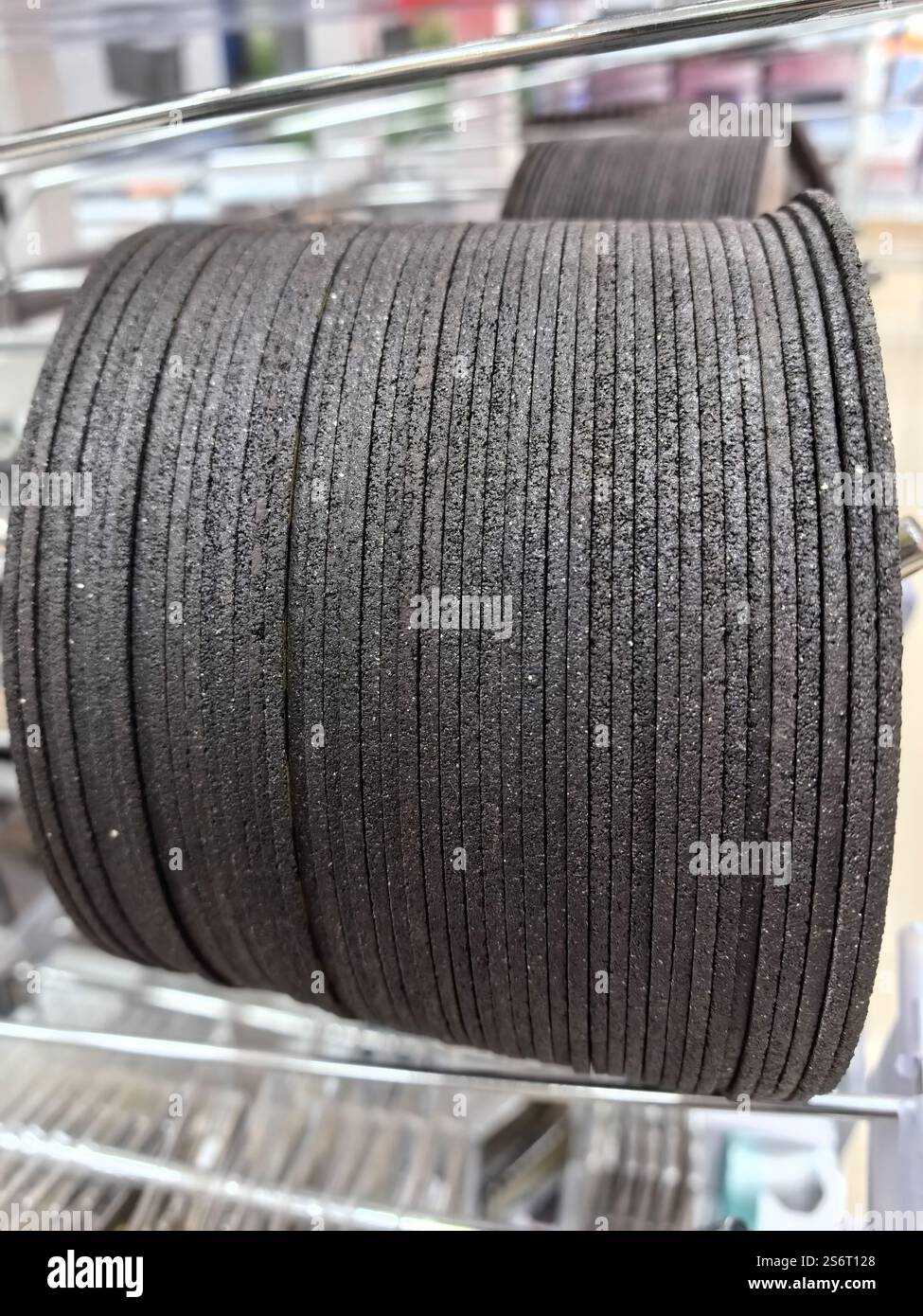 A collection of rolls showcasing thick, textured black ribbon on a ...