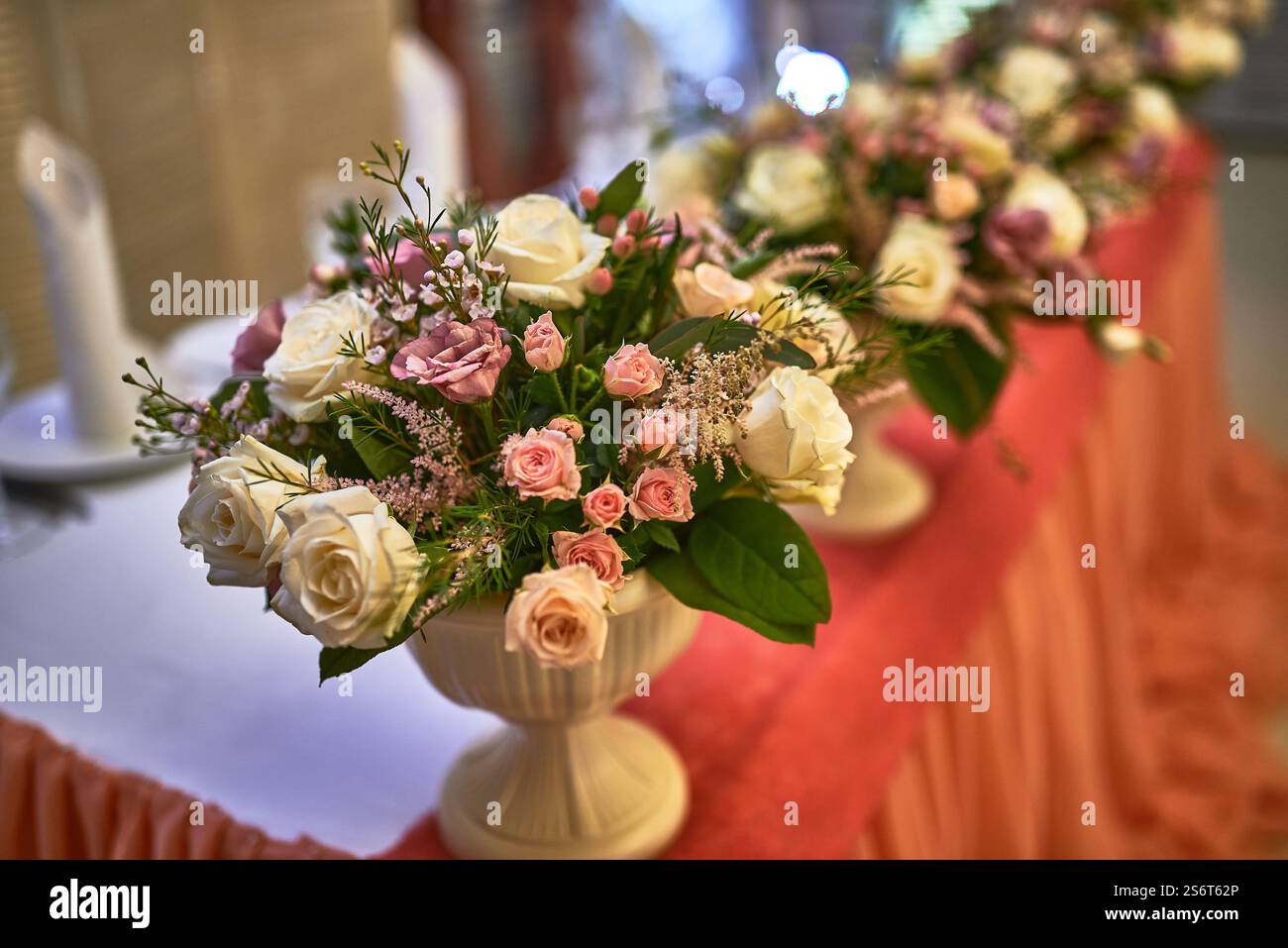Elegant floral decor featuring roses, lush greenery, and delicate pink ...