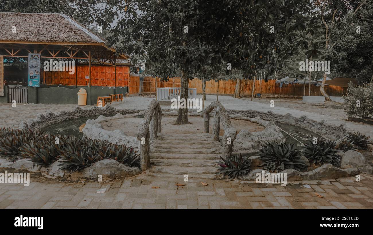 A serene outdoor area featuring a circular stone pathway leading to a ...