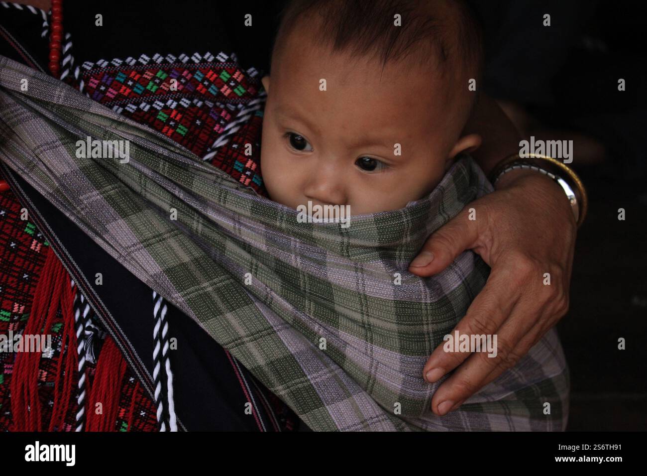 Karen baby and his grandmother in traditional outfit at a wedding near ...