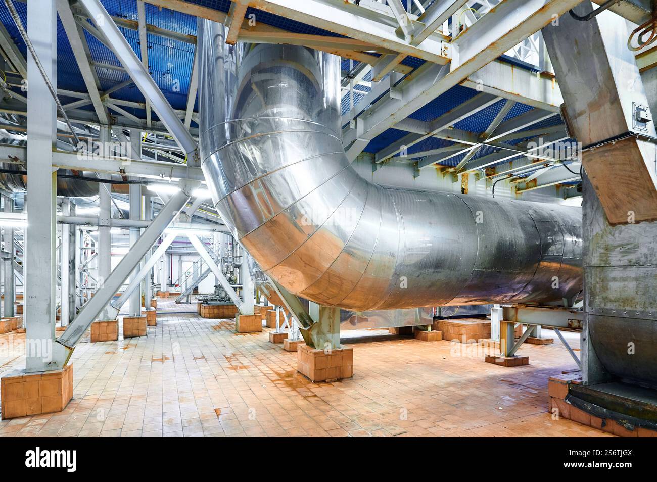 A view of industrial pipelines and conveyor systems inside a chemical ...