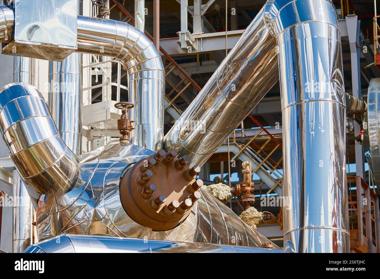 Industrial chemical plant featuring large metallic pipes and valves ...