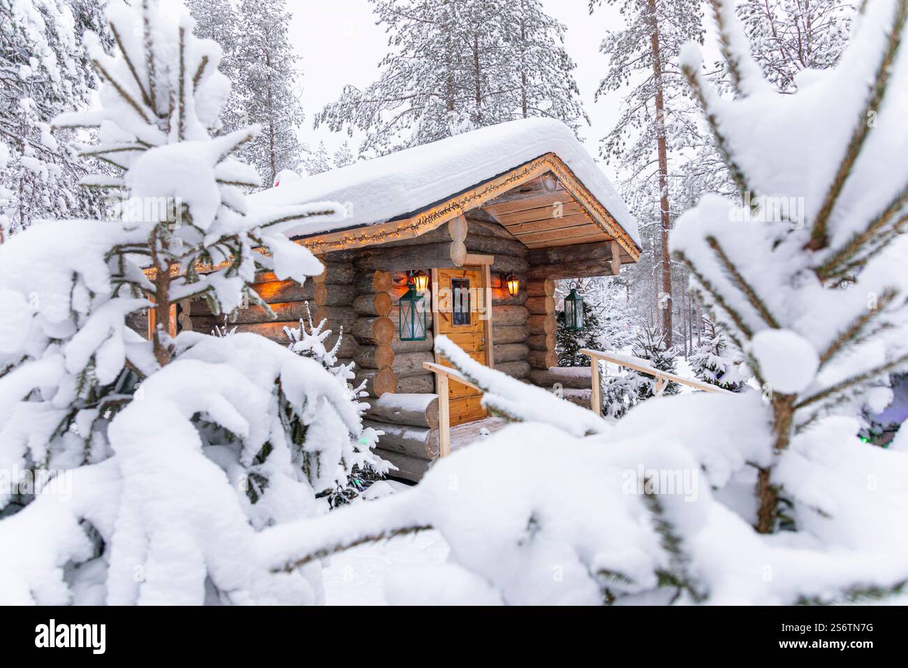 Scandinavia, Lapland, Finland. Rovaniemi. Log cabin in the snow Stock ...