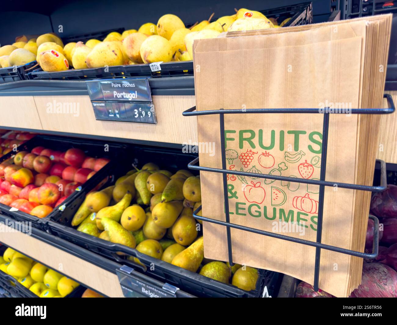 Fruit and vegetable section in a supermarket with a paper bag dispenser ...