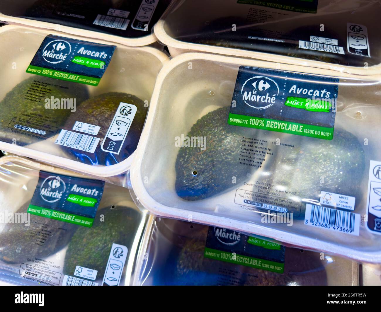 Avocado in plastic packaging. A 100% recyclable tray Stock Photo - Alamy