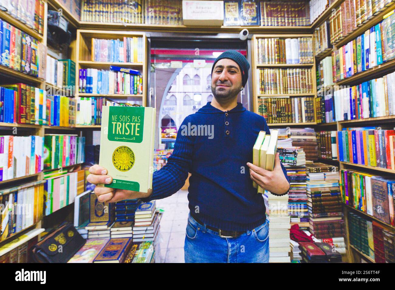 Jordan, Middle East, Amman. Al Balad district, bookseller posing with a ...