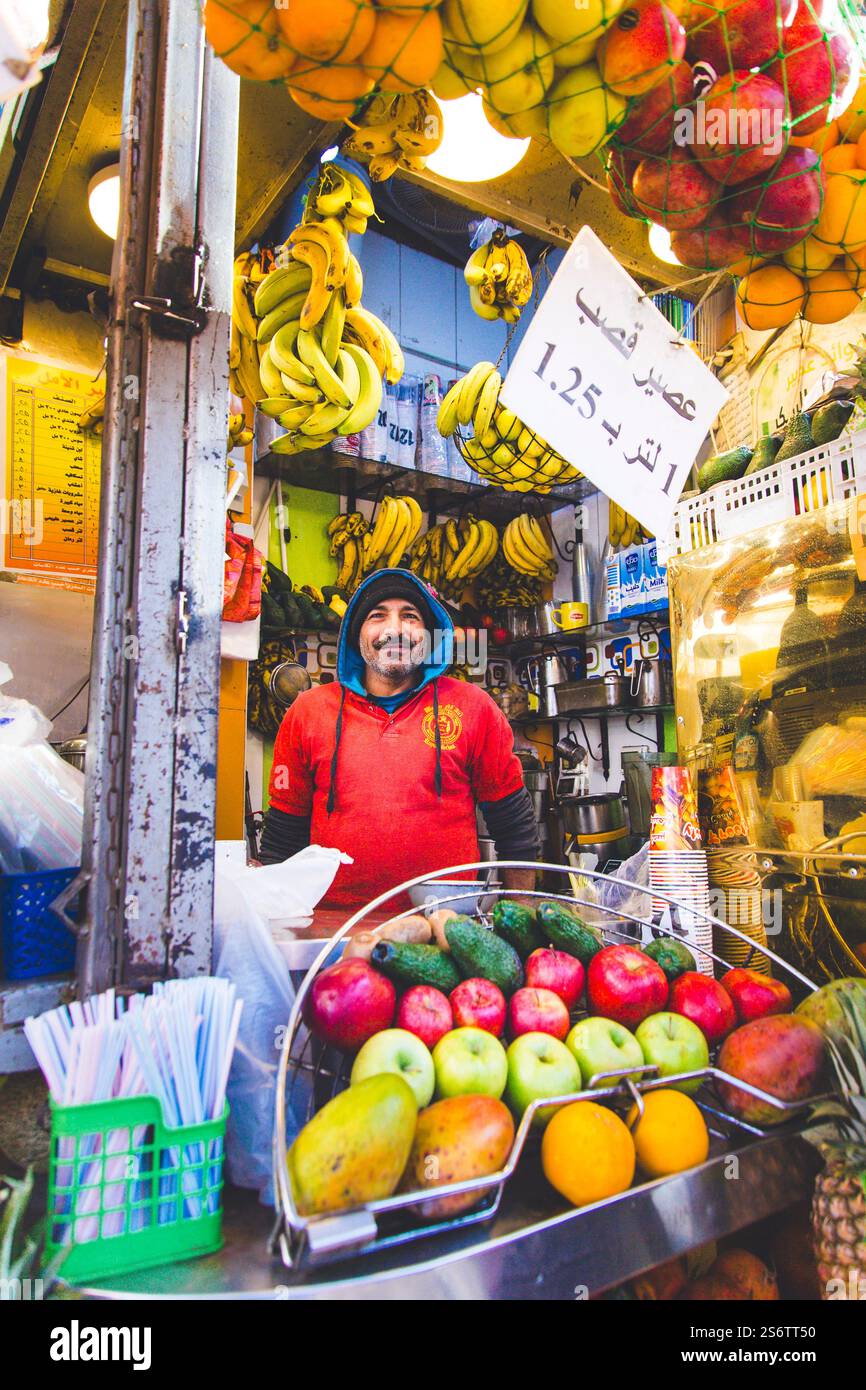 Jordan, Middle East, Amman. Al Balad district, fruit vendor, posing ...