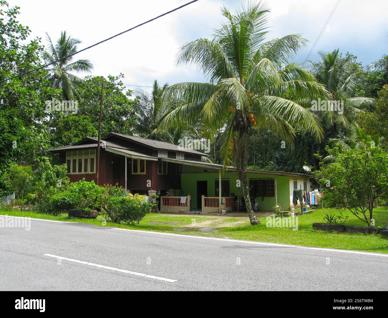 A typical traditional Malay wooden house on stilts in the village of ...